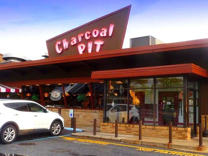 The iconic A-frame roof of Charcoal Pit stands like a mid-century beacon on Concord Pike, promising burger bliss to all who enter.