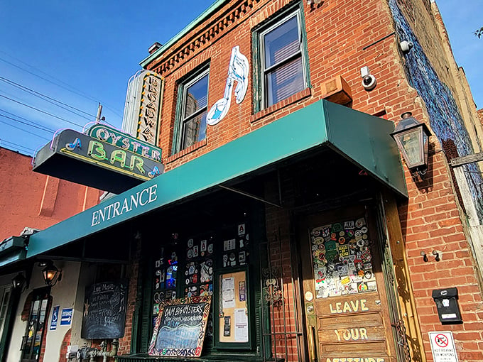 The historic brick facade of Broadway Oyster Bar welcomes seafood lovers with its vibrant green awning and door plastered with memories of good times past.
