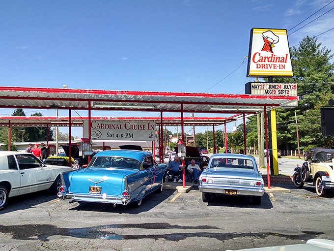 The iconic Cardinal Drive-In sign stands tall against the Carolina blue sky, beckoning hungry travelers with its retro charm and promise of comfort food paradise.