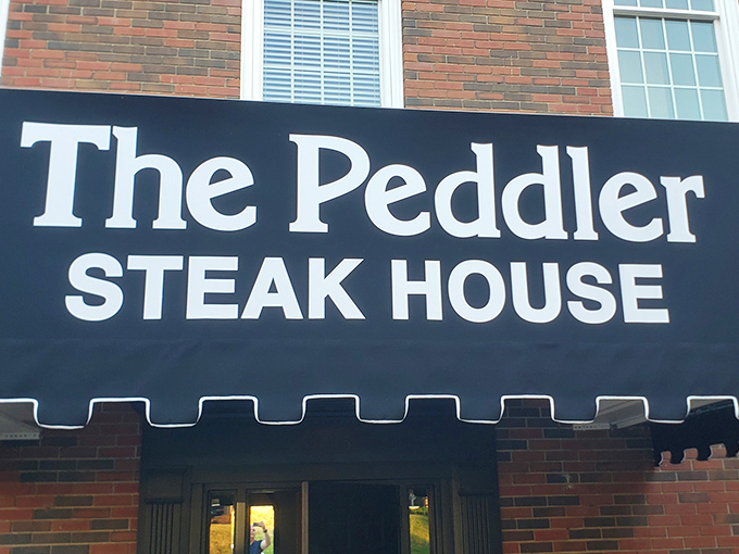 The brick fa&ccedil;ade of The Peddler stands like a carnivore's lighthouse, beckoning hungry travelers with its classic steakhouse promise. Some buildings just look delicious.
