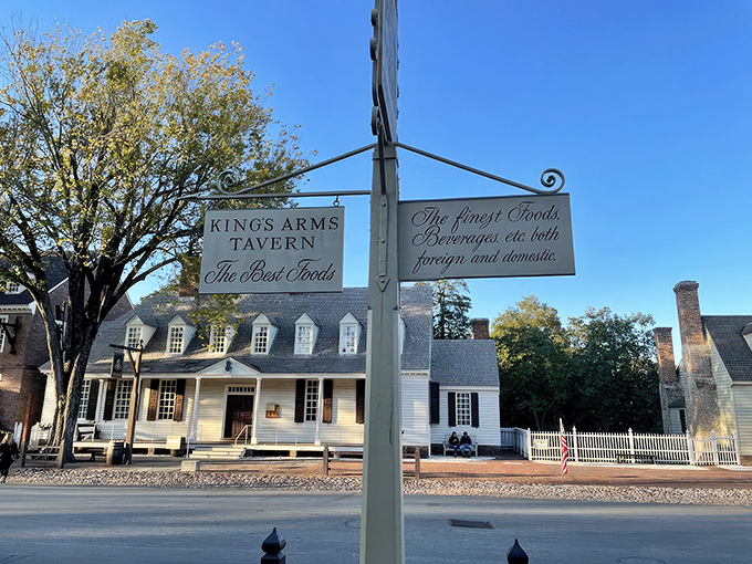 Colonial charm meets twilight magic at King's Arms Tavern, where the glowing windows promise warmth and "GOOD EATING" after a day of historical wanderings.