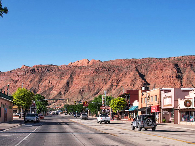 Main Street Moab, where pickup trucks are the fashion statement and those red rock backdrops aren't painted&mdash;Mother Nature just showing off.