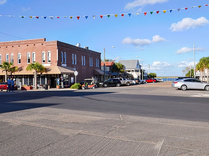 Downtown Apalachicola greets visitors with colorful bunting and historic brick buildings that whisper stories of Florida's maritime past.