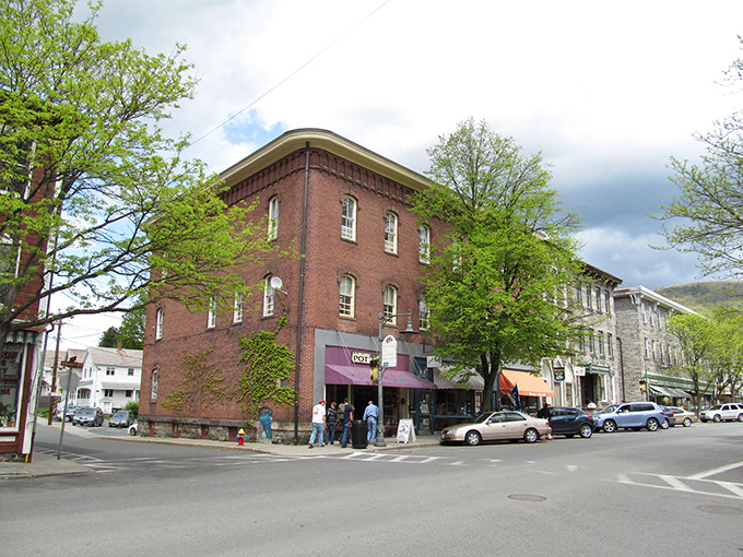 Historic brick buildings stand sentinel at Shelburne Falls' crossroads, where small-town charm meets architectural character that Norman Rockwell would have sketched with glee.