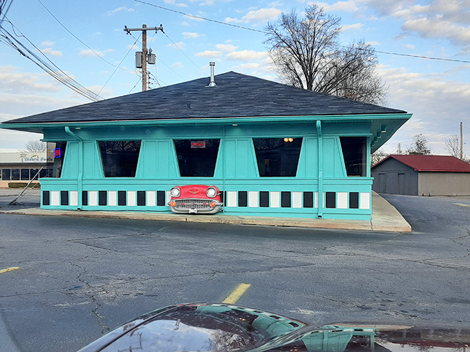 The turquoise time capsule beckons from the roadside, complete with classic car grille built right into the fa&ccedil;ade. Mid-century perfection awaits inside.