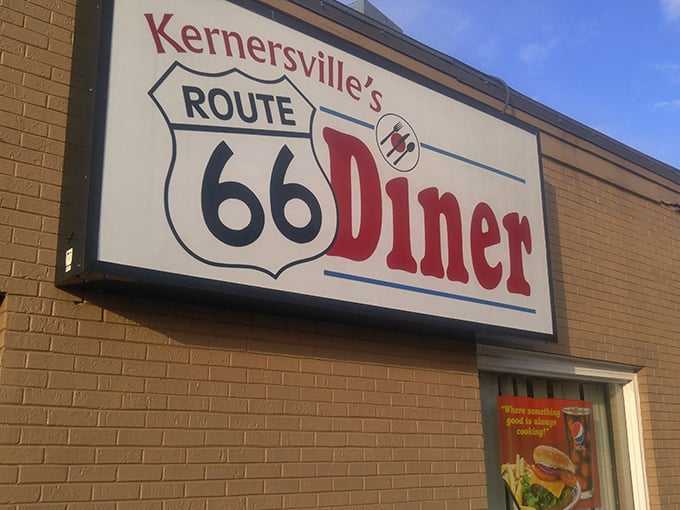 The iconic shield-shaped sign beckons like a time machine disguised as a roadside beacon. Classic Americana awaits inside!