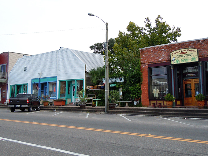 Downtown Apalachicola greets visitors with colorful bunting and historic brick buildings that whisper stories of Florida's maritime past.