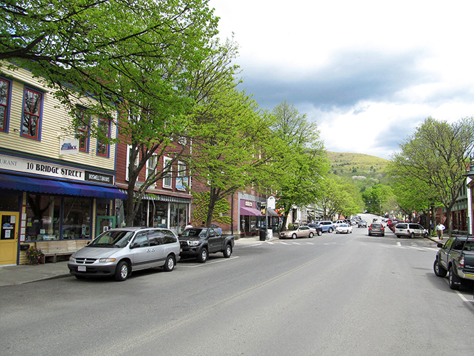 Historic brick buildings stand sentinel at Shelburne Falls' crossroads, where small-town charm meets architectural character that Norman Rockwell would have sketched with glee.