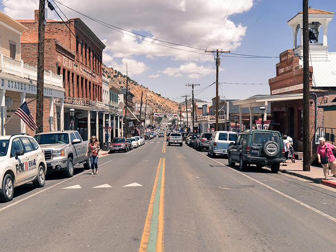 C Street stretches before you like a living museum, where Victorian-era buildings stand shoulder to shoulder under Nevada's impossibly blue sky.