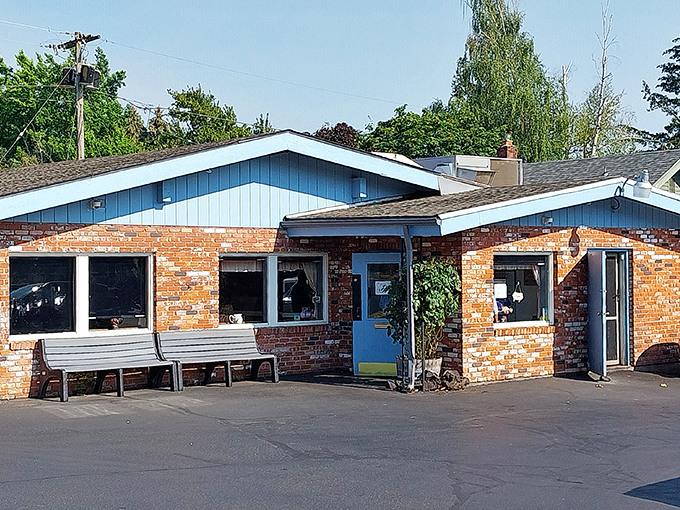 The unassuming brick exterior of Sybil's belies the breakfast magic happening inside. Blue trim and waiting benches hint at the diner's popularity.