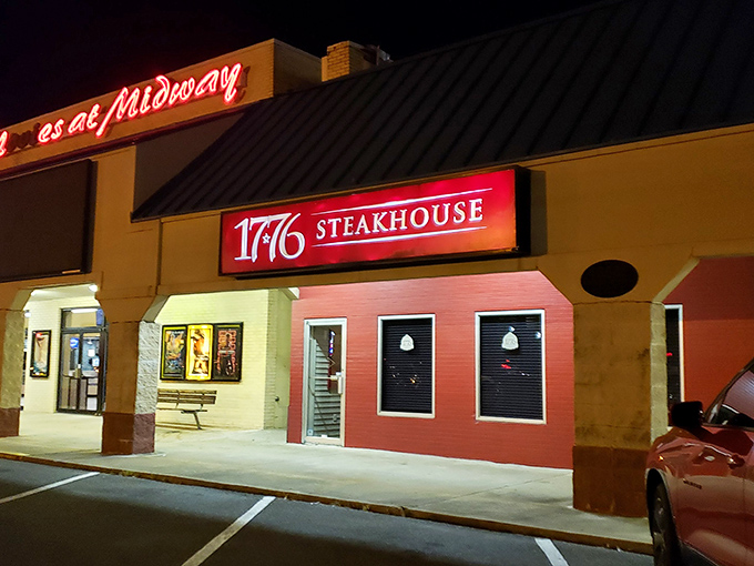 The bold red exterior of 1776 Steakhouse stands as a patriotic beacon for carnivores, promising revolutionary flavors behind those unassuming windows.