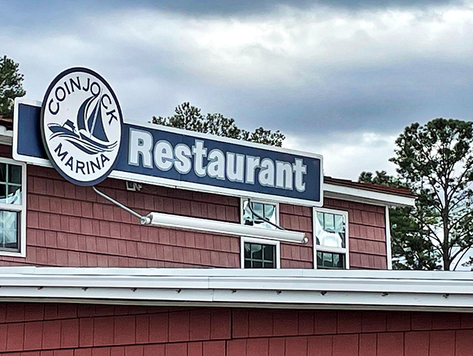 The unassuming pink exterior of Coinjock Marina Restaurant&mdash;proof that culinary treasures often hide in plain sight along North Carolina's waterways.