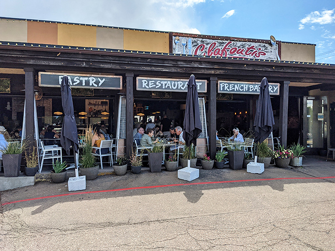 The unassuming exterior of Clafoutis beckons like a French postcard come to life, complete with charming patio seating perfect for people-watching with your pain au chocolat.