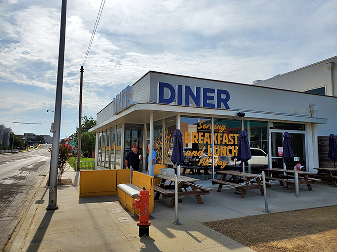 The iconic blue "DINER" sign beckons like a lighthouse for the breakfast-starved, promising all-day comfort in the heart of OKC.
