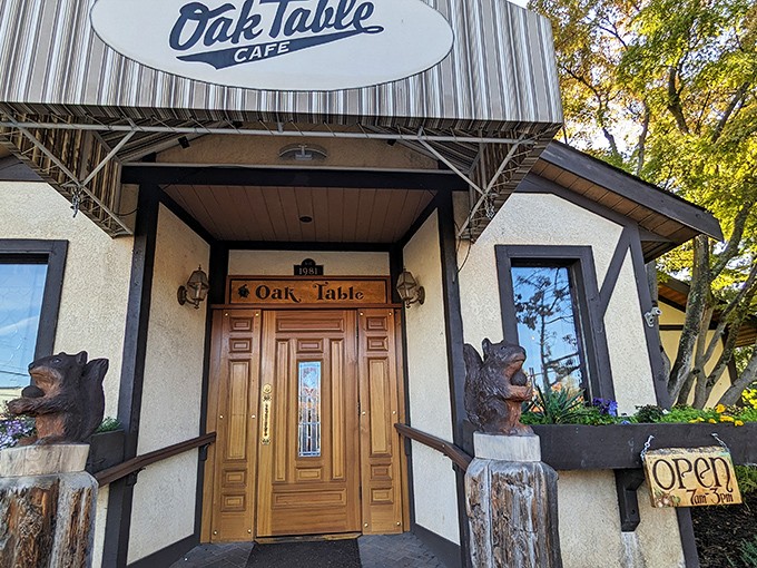 The entrance to breakfast paradise! Wooden bears stand guard at The Oak Table Cafe's doorway, promising a Pacific Northwest dining experience worth waking up for.