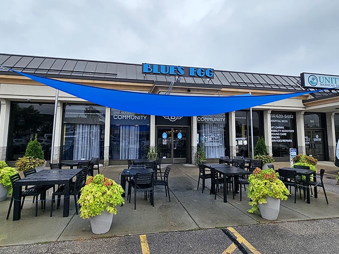 The blue awning beckons like a breakfast lighthouse, guiding hungry souls to this Milwaukee morning haven where French toast dreams come true.