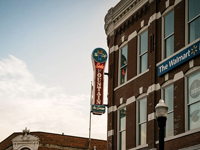 The corner brick building stands like a sentinel of sweetness, promising cold comfort on hot Arkansas afternoons with its classic soda fountain charm.