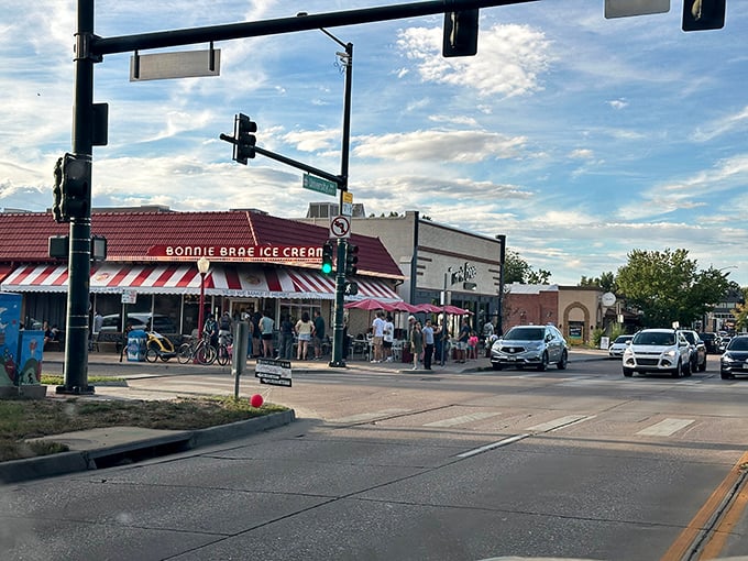 The iconic red-striped awning of Bonnie Brae Ice Cream stands as Denver's beacon of frozen happiness, drawing crowds even on chilly Colorado evenings.