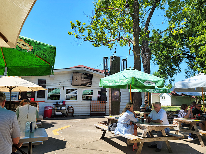 The charming cottage-like exterior of Grinders Stonewall beckons with its red-trimmed sign and helpful "ENTER OVER HERE" arrow&mdash;like your coolest friend's secret hideaway.