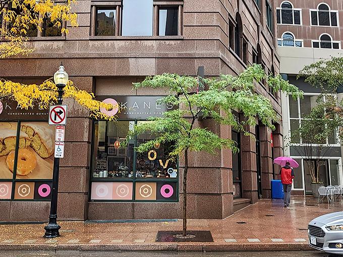 Kane's iconic storefront in Boston's Financial District beckons like a pink-glazed lighthouse to donut lovers navigating the urban sea of steel and stone.