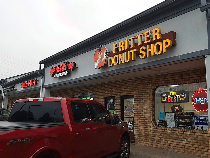 The yellow block letters against brick might not scream "culinary destination," but locals know this humble storefront houses donut royalty.