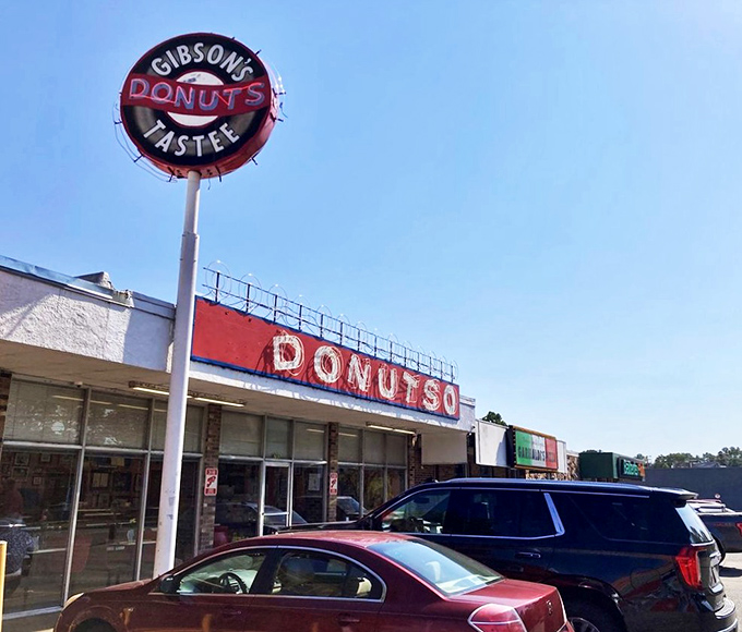 The iconic Gibson's sign stands like a beacon for donut lovers, promising sweet salvation beneath those bold red letters stretching across the Memphis skyline.