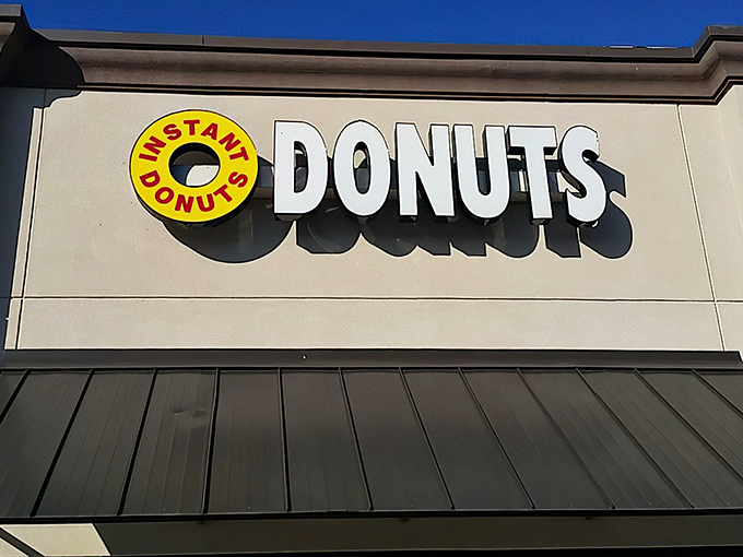 The unassuming yellow and white sign of Instant Donuts beckons from its strip mall home—proof that culinary treasures often hide in plain sight.