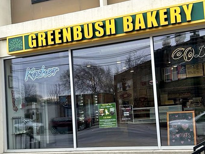 The iconic green and yellow storefront of Greenbush Bakery stands as a beacon of hope for donut lovers across Madison. That neon "Kosher" sign promises authentic goodness inside. 