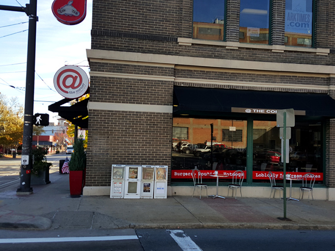 The iconic red and white circular sign beckons hungry travelers to this brick corner building, promising comfort food with urban style.