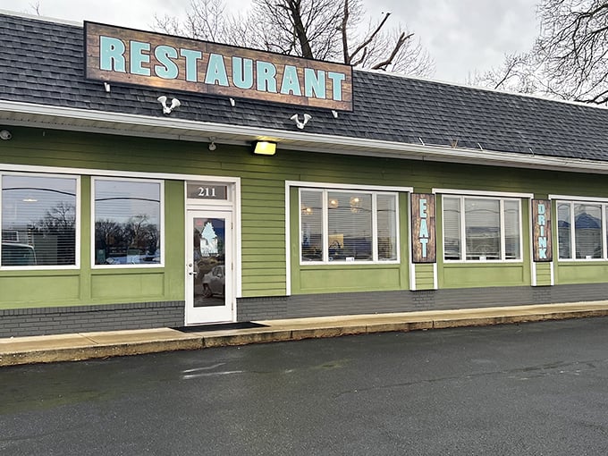 The modest lime-green exterior of The Backyard hides culinary treasures within, proving you should never judge a restaurant by its siding.