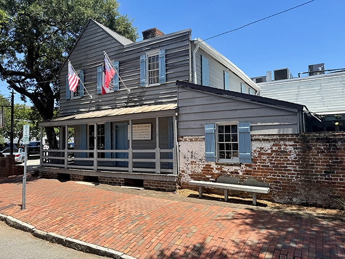 The historic blue-shuttered facade of The Pirates' House stands as a Georgian time capsule, welcoming hungry travelers just as it has since 1753.