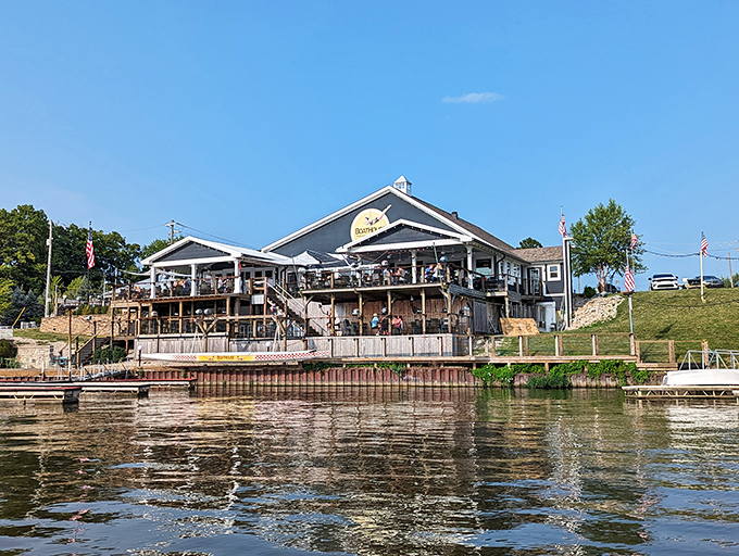 The blue-gray exterior of Boathouse Kitchen & Swan Dive stands ready to welcome hungry visitors, a lakeside beacon for flavor-seekers on Morse Reservoir.