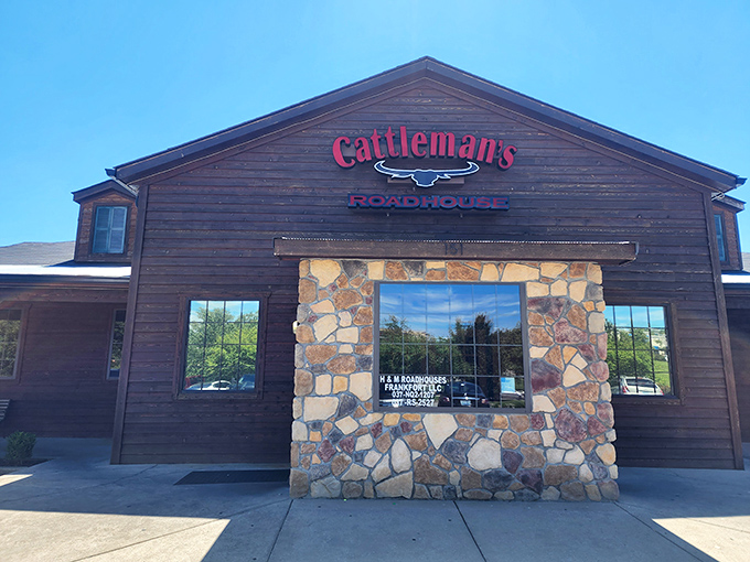 The rustic wooden exterior of Cattleman's Roadhouse beckons like an old friend, promising comfort and satisfaction within those stone-accented walls.