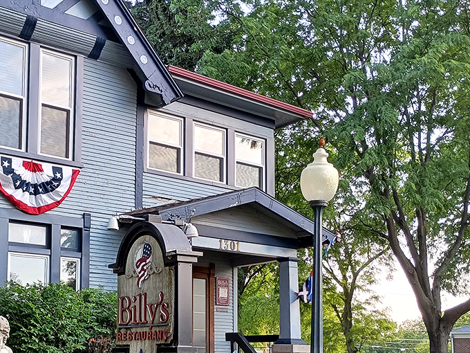 Billy's blue Victorian exterior isn't just charming&mdash;it's a culinary time machine disguised as your fancy aunt's house. The patriotic bunting adds a perfect touch.