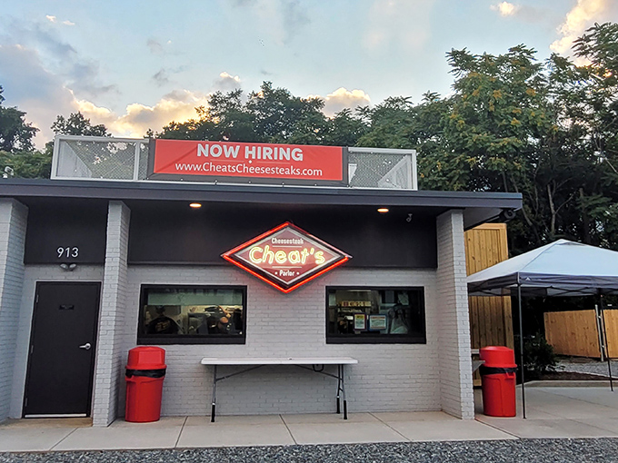 The unassuming white brick exterior of Cheat's Cheesesteaks proves once again that culinary treasures often hide in the simplest packages.