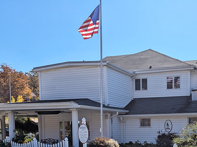 The white clapboard exterior with its American flag announces itself without pretense&mdash;like that reliable friend who never changes but always delivers the goods.