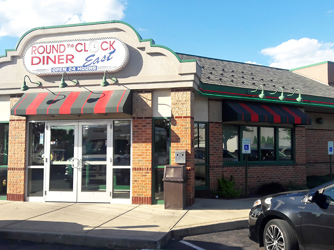 The classic brick exterior with its red and green awning stands like a beacon to hungry travelers. Diner paradise awaits 24/7! 