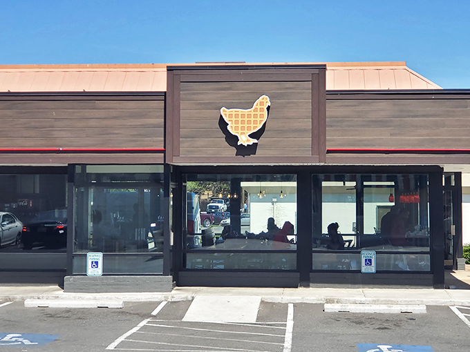 The glowing sign of Uncle C's beckons hungry travelers like a lighthouse for the famished. Modern exterior with classic comfort food promise.