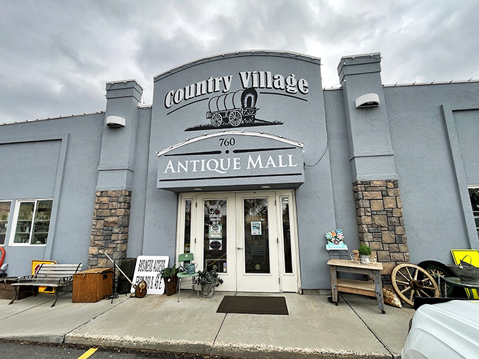 The unassuming exterior of Country Village Antique Mall belies the wonderland within, like a time-travel portal disguised as a suburban building. 