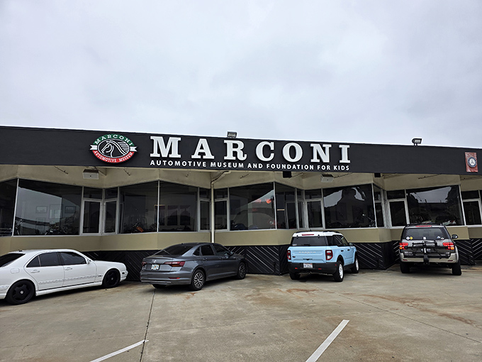 The unassuming exterior of Marconi Automotive Museum belies the treasures within, like finding a Ferrari dealership hiding behind what looks like your accountant's office.