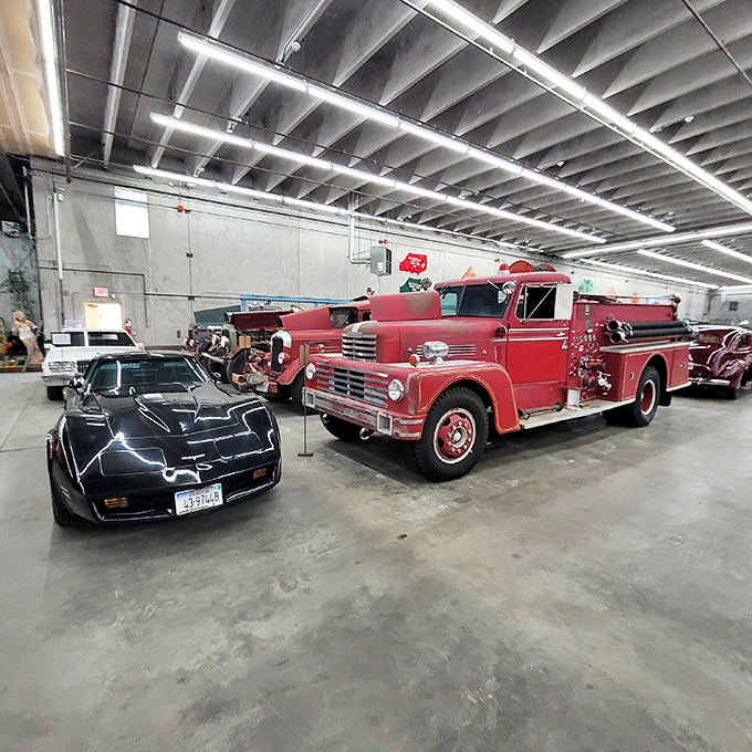 Knight Rider meets firefighting history! This sleek black Corvette parked beside a vintage fire truck shows how dramatically automotive design evolved while maintaining that unmistakable American flair.