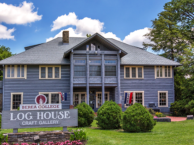 The stately blue Log House Craft Gallery stands like a guardian of Appalachian tradition, proudly displaying its Berea College heritage beneath Kentucky's endless sky.