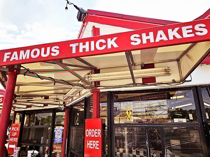 The iconic red and white striped exterior of Iceberg Drive Inn stands like a time capsule on 3900 South, promising nostalgic delights within.