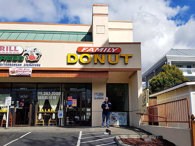 The yellow "DONUT" sign beckons like a lighthouse guiding sugar-seeking ships through morning fog. This unassuming storefront holds Seattle's sweetest treasures.
