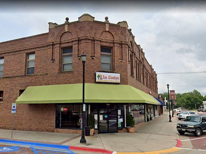 La Cocina's unassuming brick exterior with its cheerful green awning stands as Seward's culinary beacon, promising Mexican treasures within.