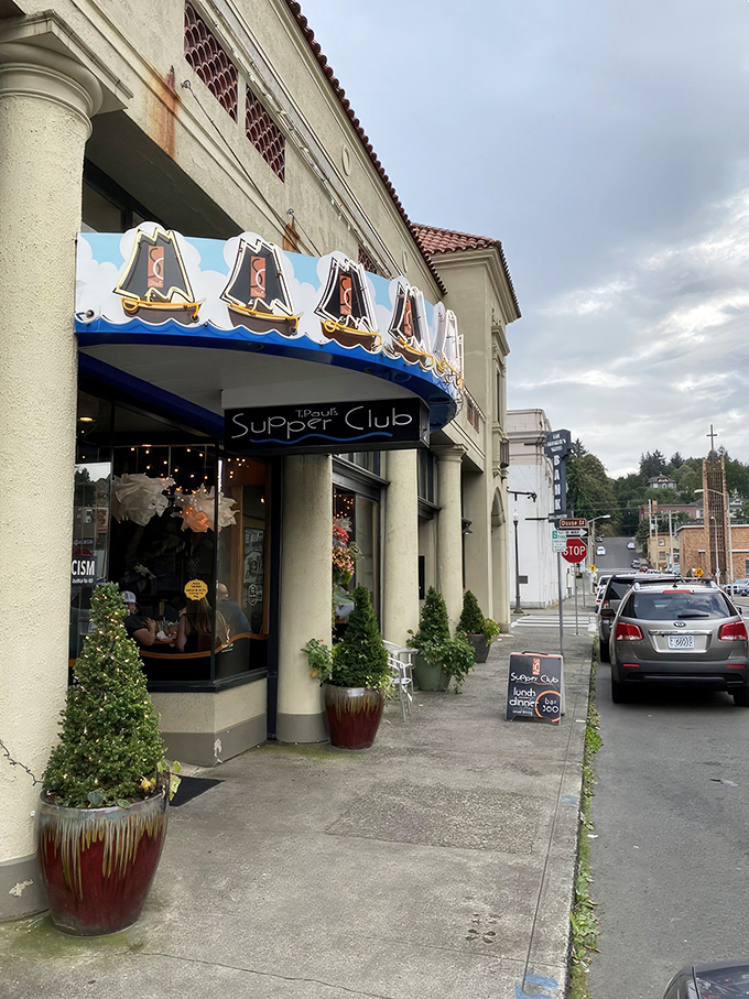The iconic blue awning with sailboat motifs welcomes you to T. Paul's Supper Club, a coastal gem where Astoria's charm meets culinary excellence. 