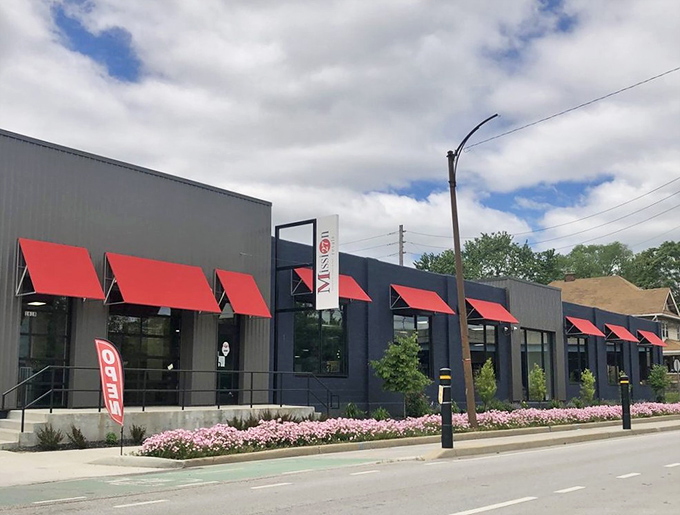 Mission 27's modern exterior with its distinctive red awnings stands as a stylish contradiction to the "thrift store" stereotype. Upscale bargain hunting begins here.