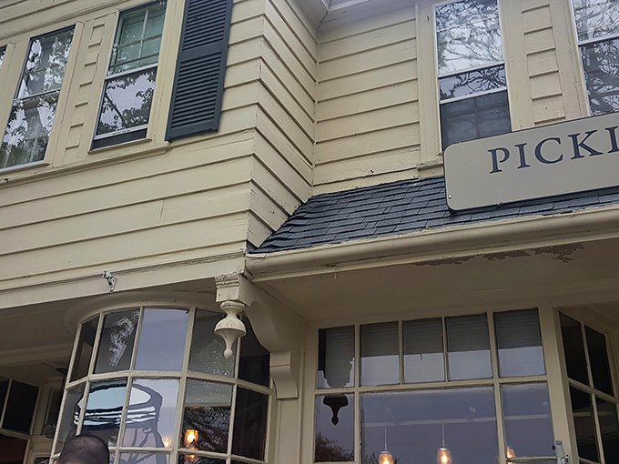 The charming yellow exterior of Pickle Jar Kitchen beckons like a culinary lighthouse on Falmouth's Main Street, promising comfort and creativity inside.