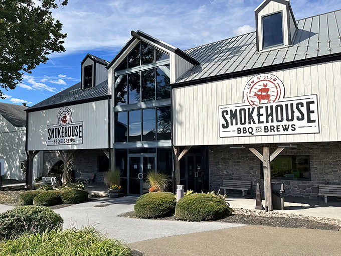 The barn-inspired exterior of Smokehouse BBQ & Brews stands proudly against the Pennsylvania sky, a beacon of smoked meat salvation in Amish Country. 
