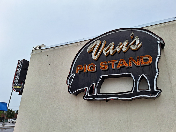 That iconic neon pig sign isn't just advertising – it's a beacon of hope for barbecue pilgrims seeking smoky salvation in Norman.